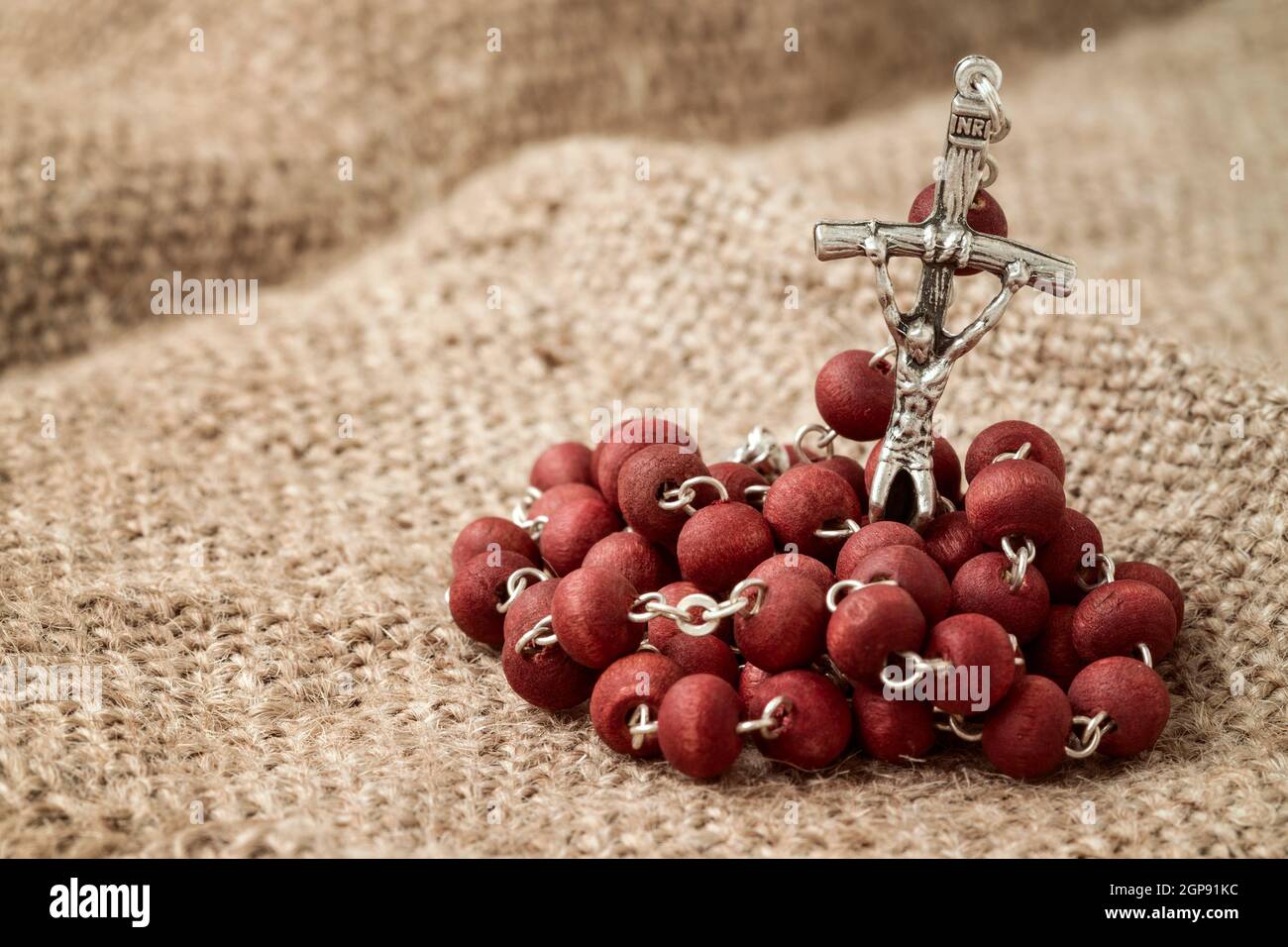 Close-up view of christian rosary on old fabric background Stock Photo ...