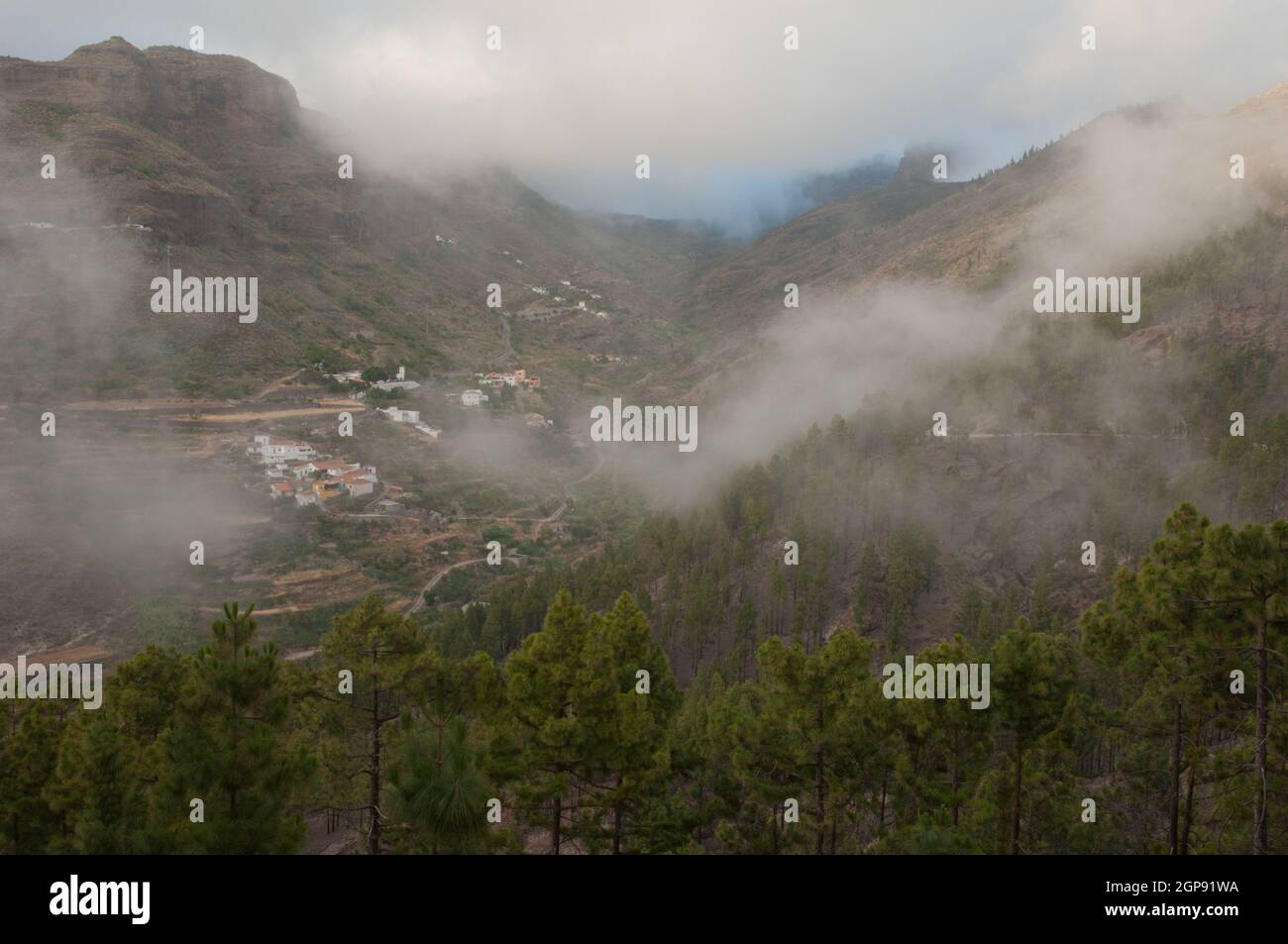 Village of El Juncal in the fog. El Juncal ravine. The Nublo Rural Park ...
