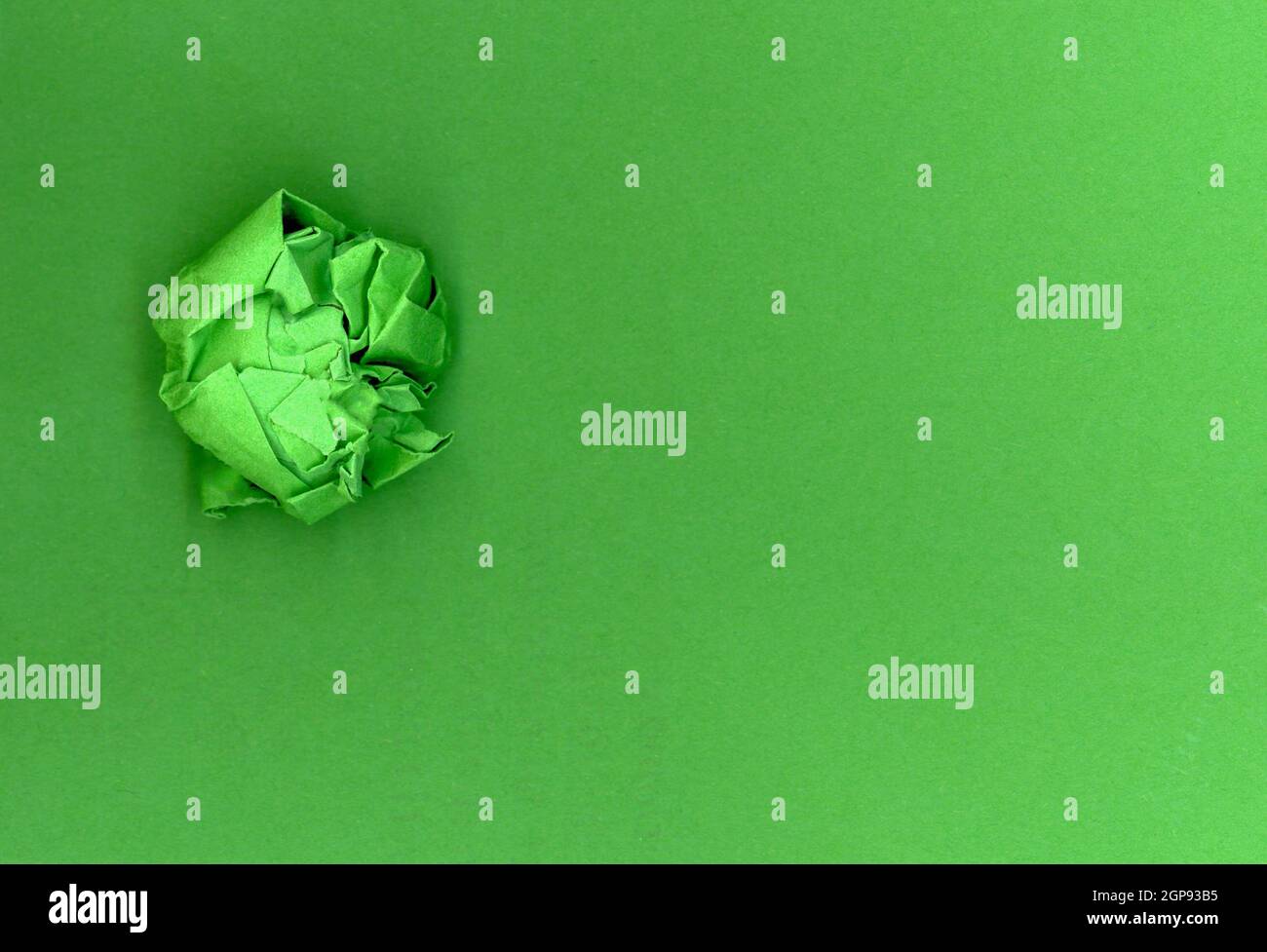 green paper ball over green cardboard background Stock Photo - Alamy