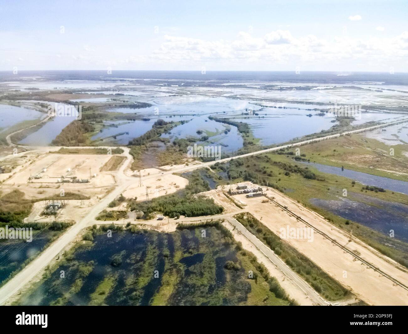Top view of the oil and gas field. Wetlands and entrances to industrial ...