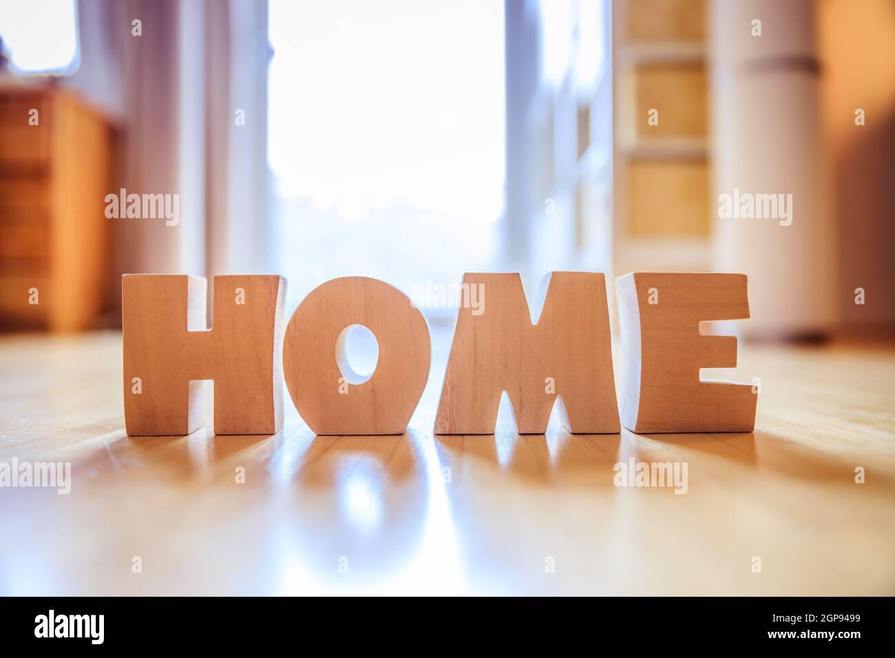 Wooden HOME Letters on the floor of an apartment Stock Photo - Alamy