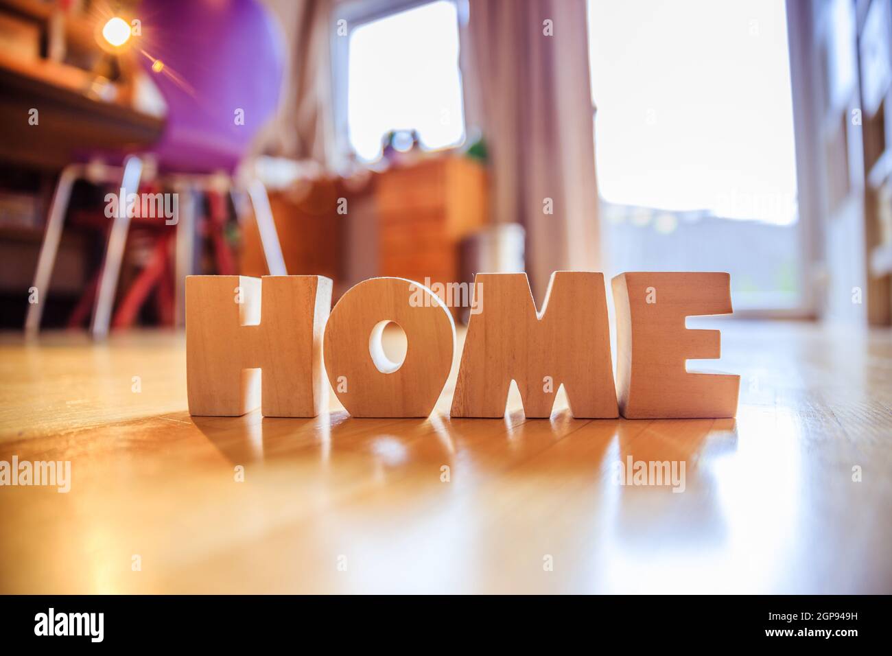 Wooden HOME Letters on the floor of an apartment Stock Photo - Alamy