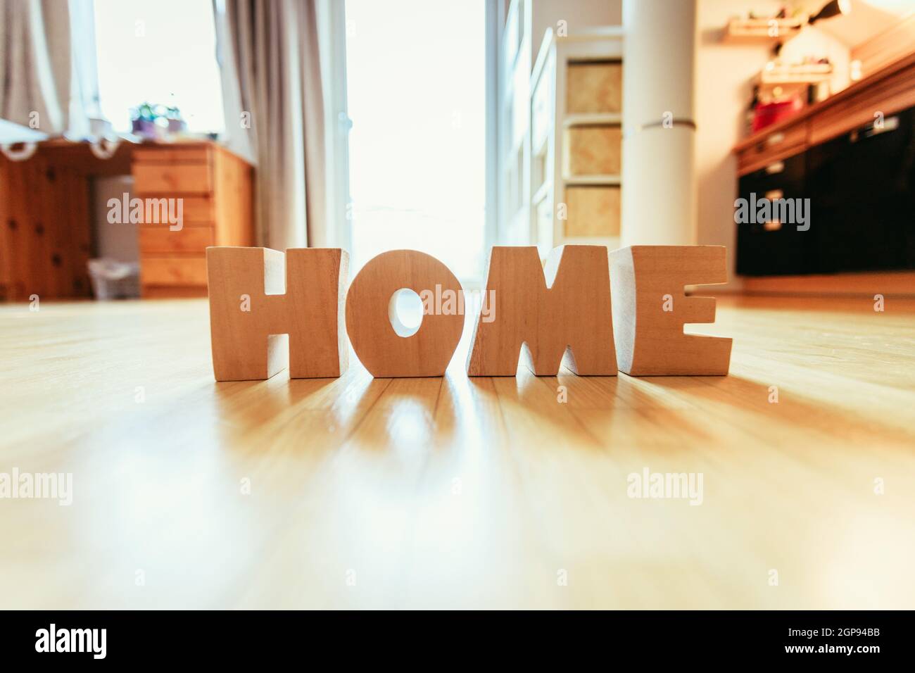 Wooden HOME Letters on the floor of an apartment Stock Photo - Alamy