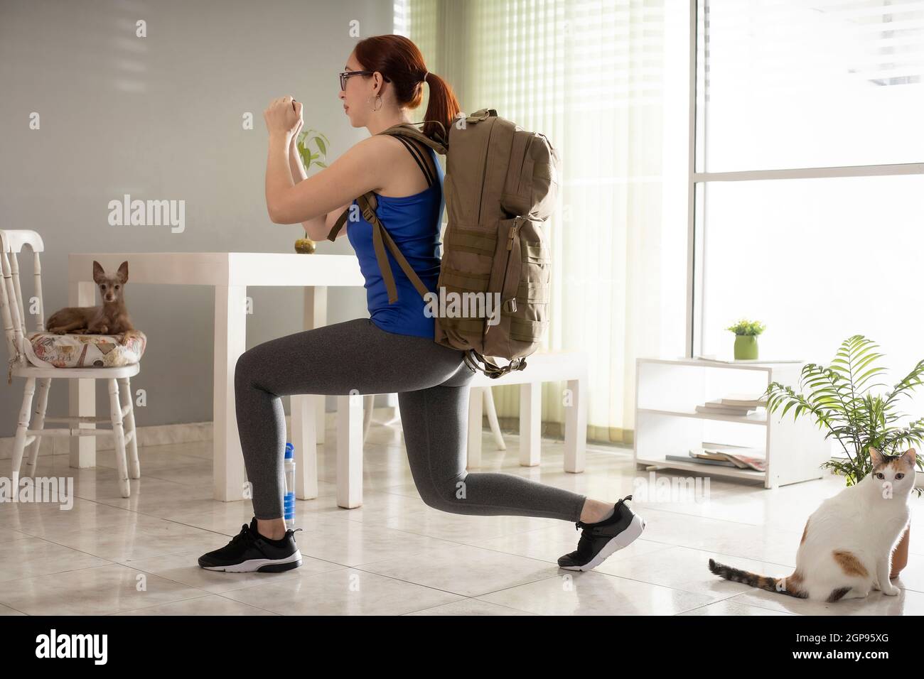 girl with collected hair and glasses in confinement with pets doing ...