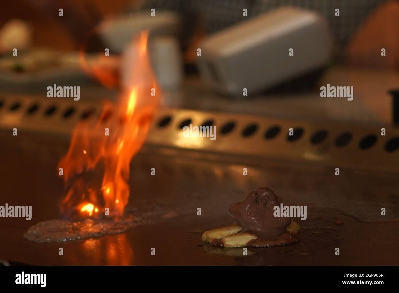Small fire on a hot steel pan in the kitchen at a restaurant Stock ...
