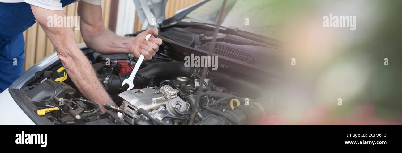Car mechanic repairing a car engine Stock Photo - Alamy
