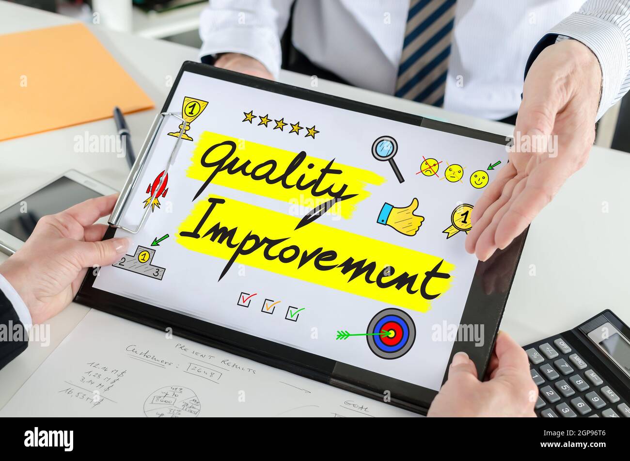 Quality improvement concept shown by a businessman Stock Photo - Alamy