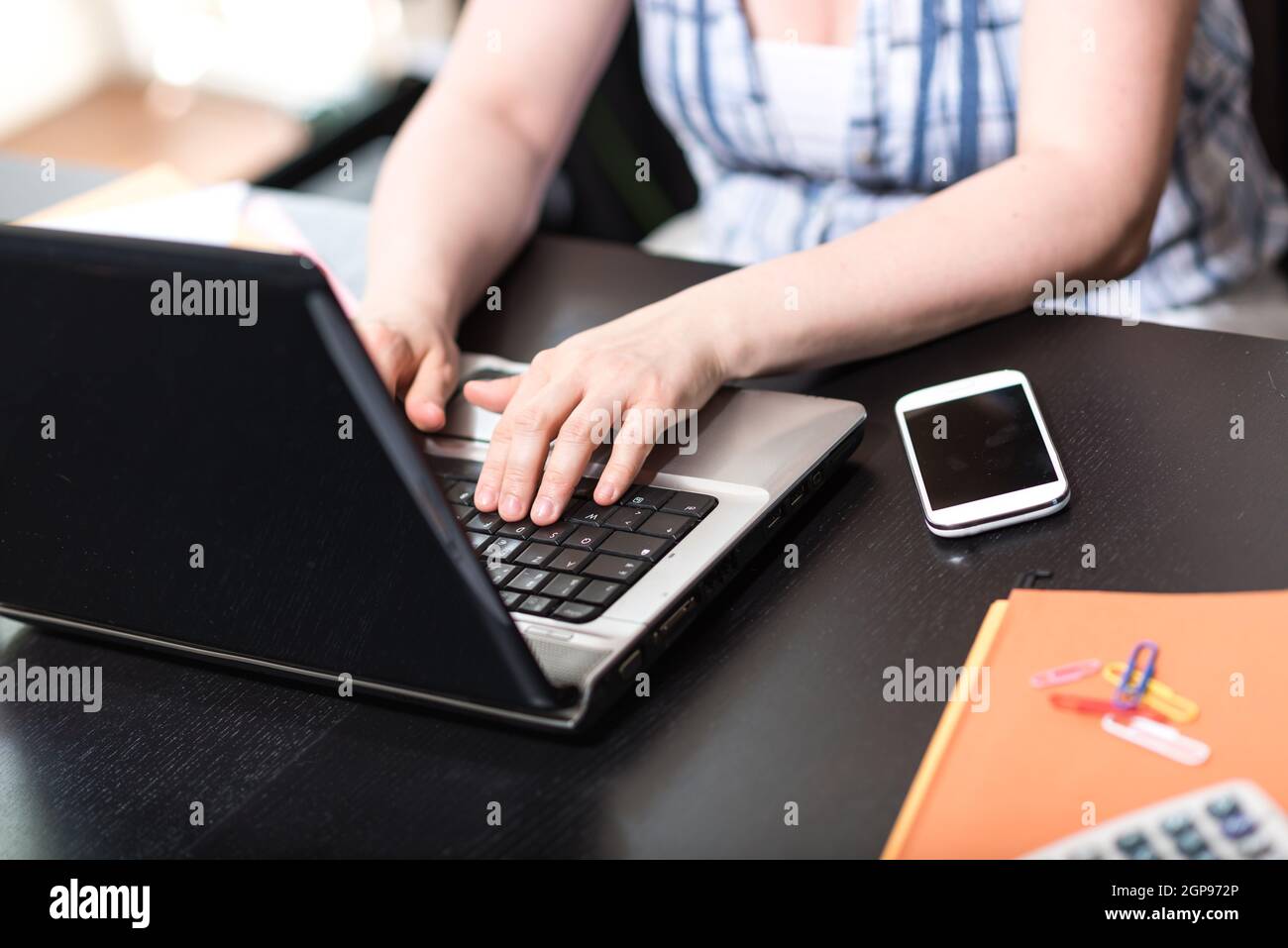 Female hands using a laptop in office Stock Photo - Alamy