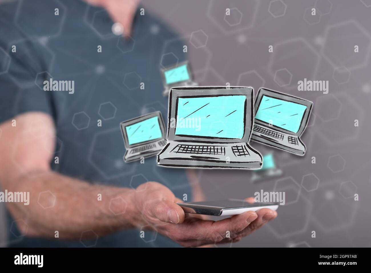 Computer concept above a smartphone held by a man in background Stock ...
