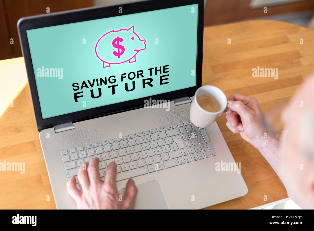 Man using a laptop with saving for the future concept on the screen ...