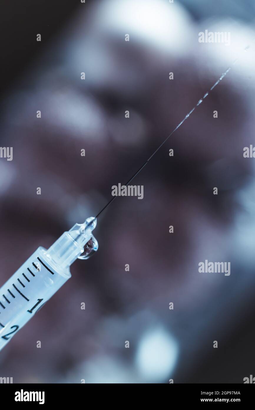 Syringe with needle up and jet and drops of medicine close up Stock ...