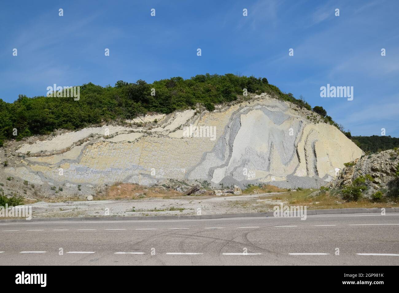 slope of the mountain with layers of sedimentary rocks. Vertically ...