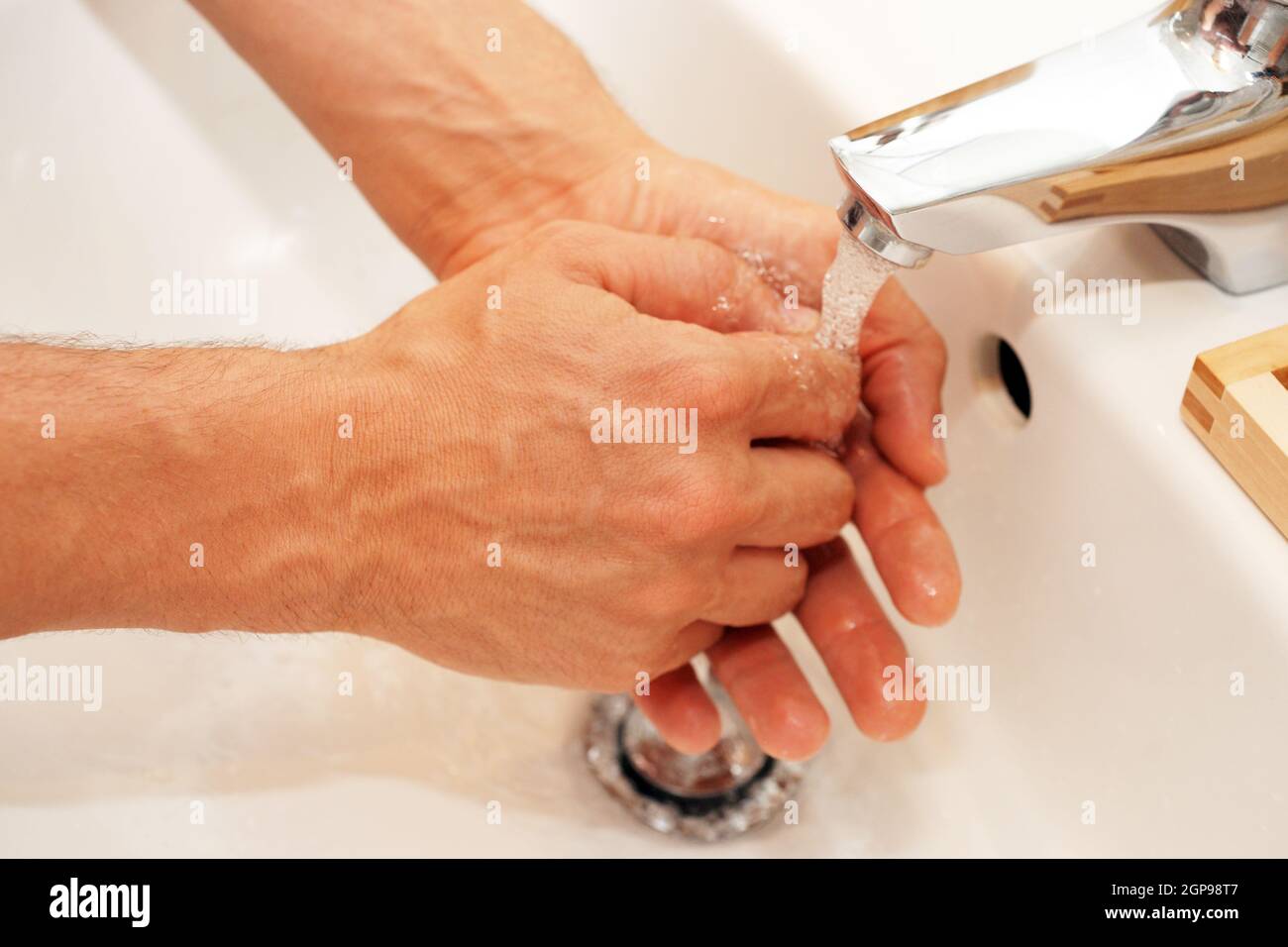 Wash hands close up- male hands using soap and tap water concept hand ...