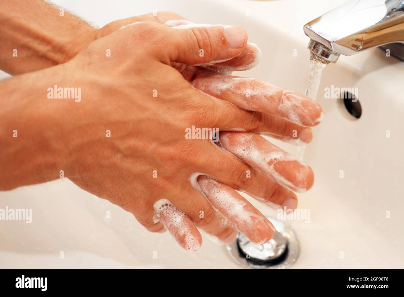 Wash hands close up- male hands using soap and tap water concept hand ...