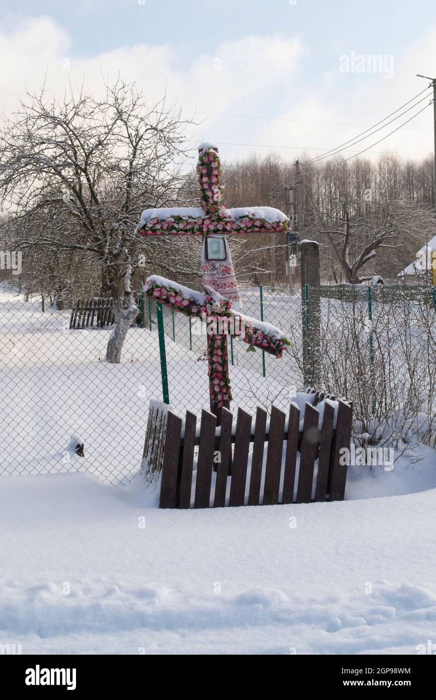 Wooden orthodox cross at the entrance to village in Belarus, winter ...