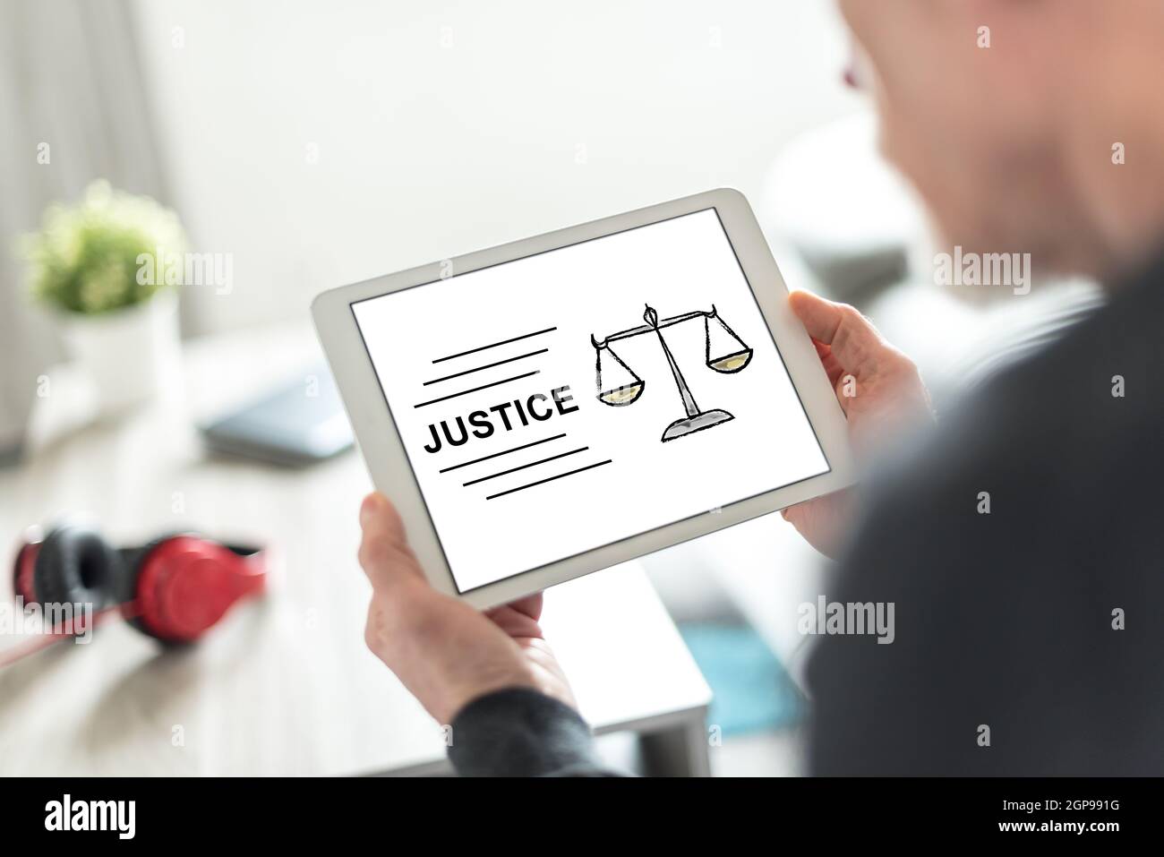 Tablet screen displaying a justice concept Stock Photo - Alamy