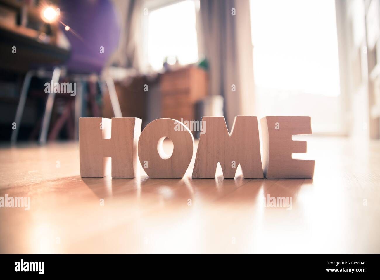 Wooden HOME Letters on the floor of an apartment Stock Photo - Alamy