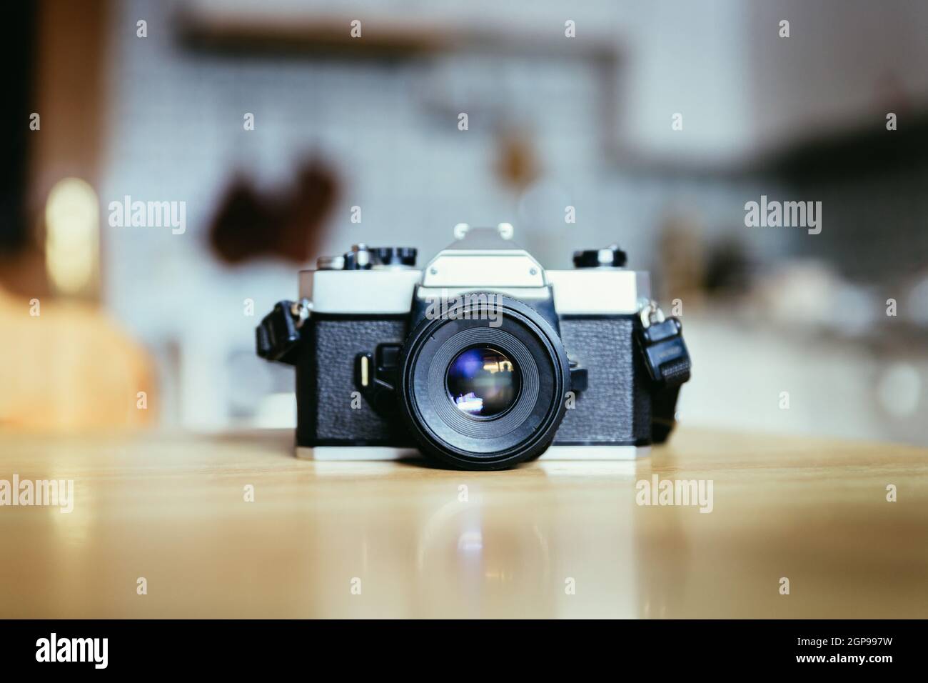 Retro vintage photography camera on kitchen table, blurry background ...