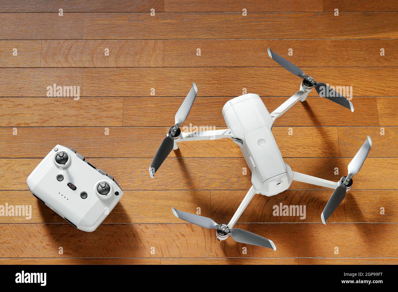 small drone copter with controller on a wooden background Stock Photo ...