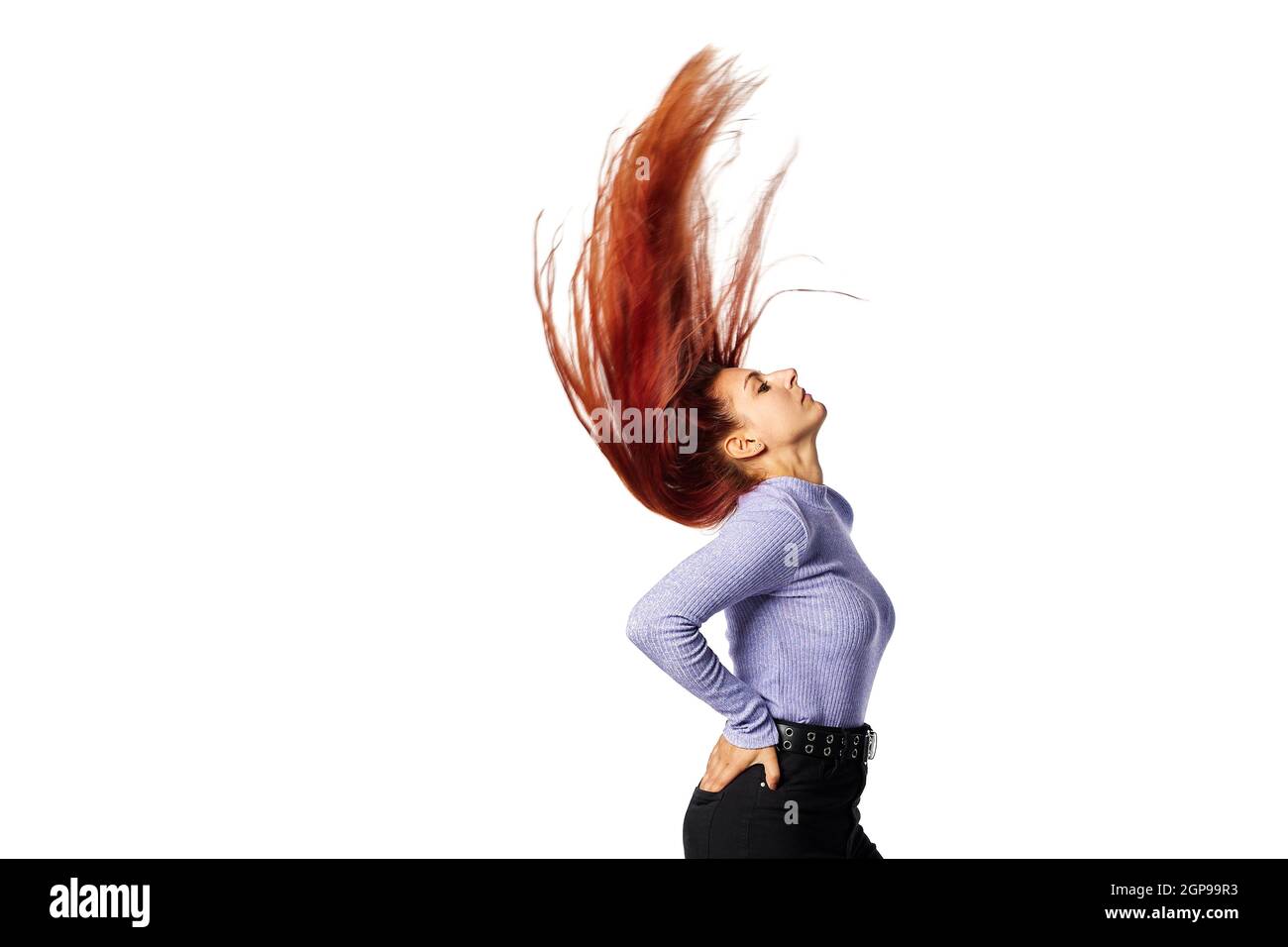 young woman on white background in isolated studio moving her hair over ...