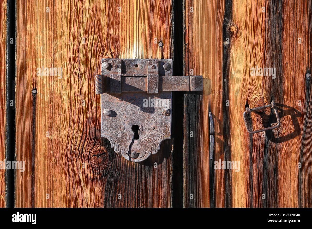Handmade old lock on a weathered wooden door Stock Photo - Alamy