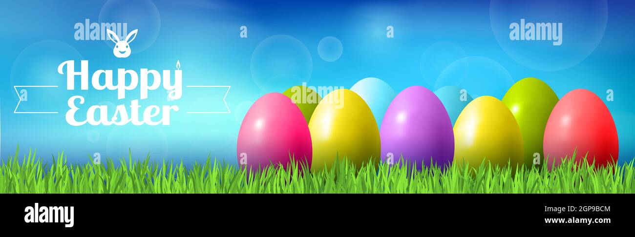 Abstract Easter bokeh background with colorful eggs lying on the grass ...