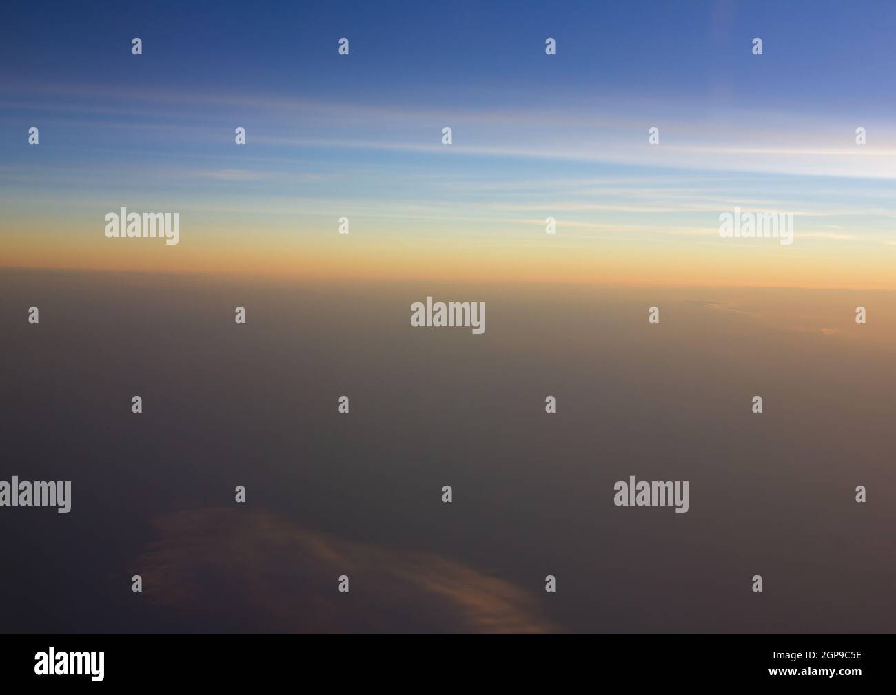 Sky and clouds at sunset bird's eye view on the plane Stock Photo - Alamy