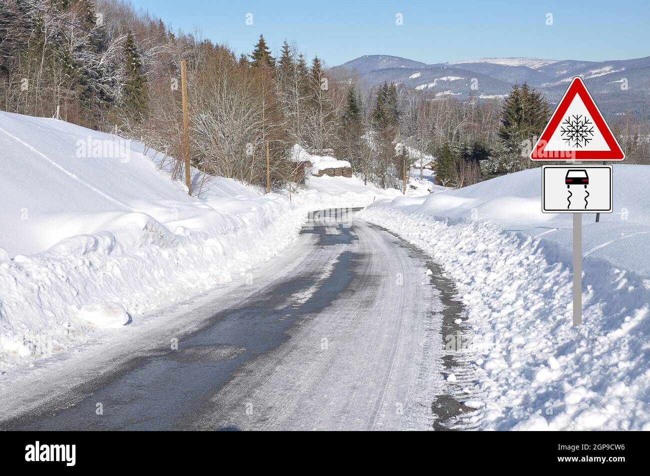 Warning sign at snow-covered road in Bavaria Stock Photo - Alamy