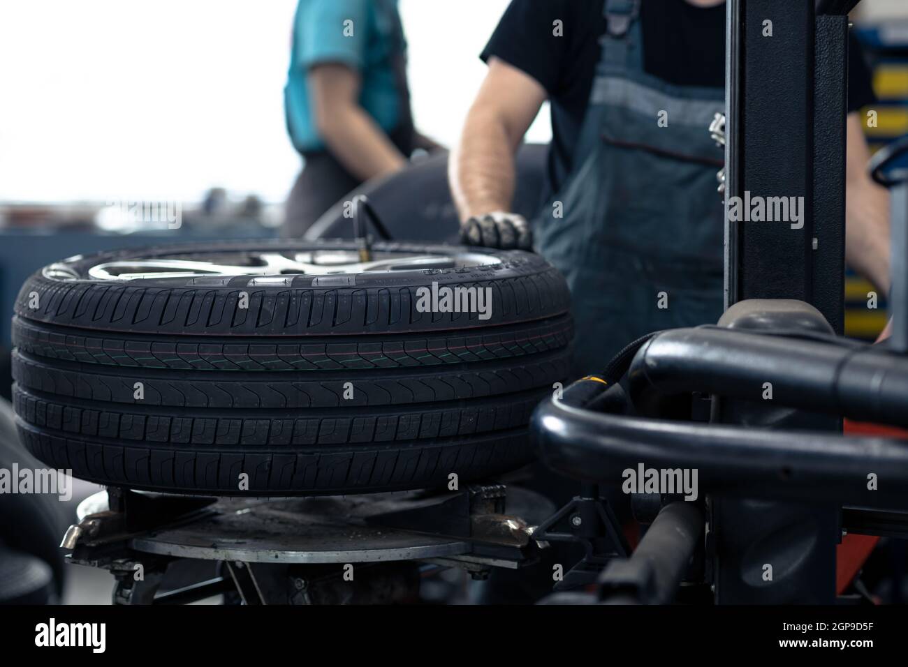 Car mechanic changing tires of a car in a repair shop,car garage ...