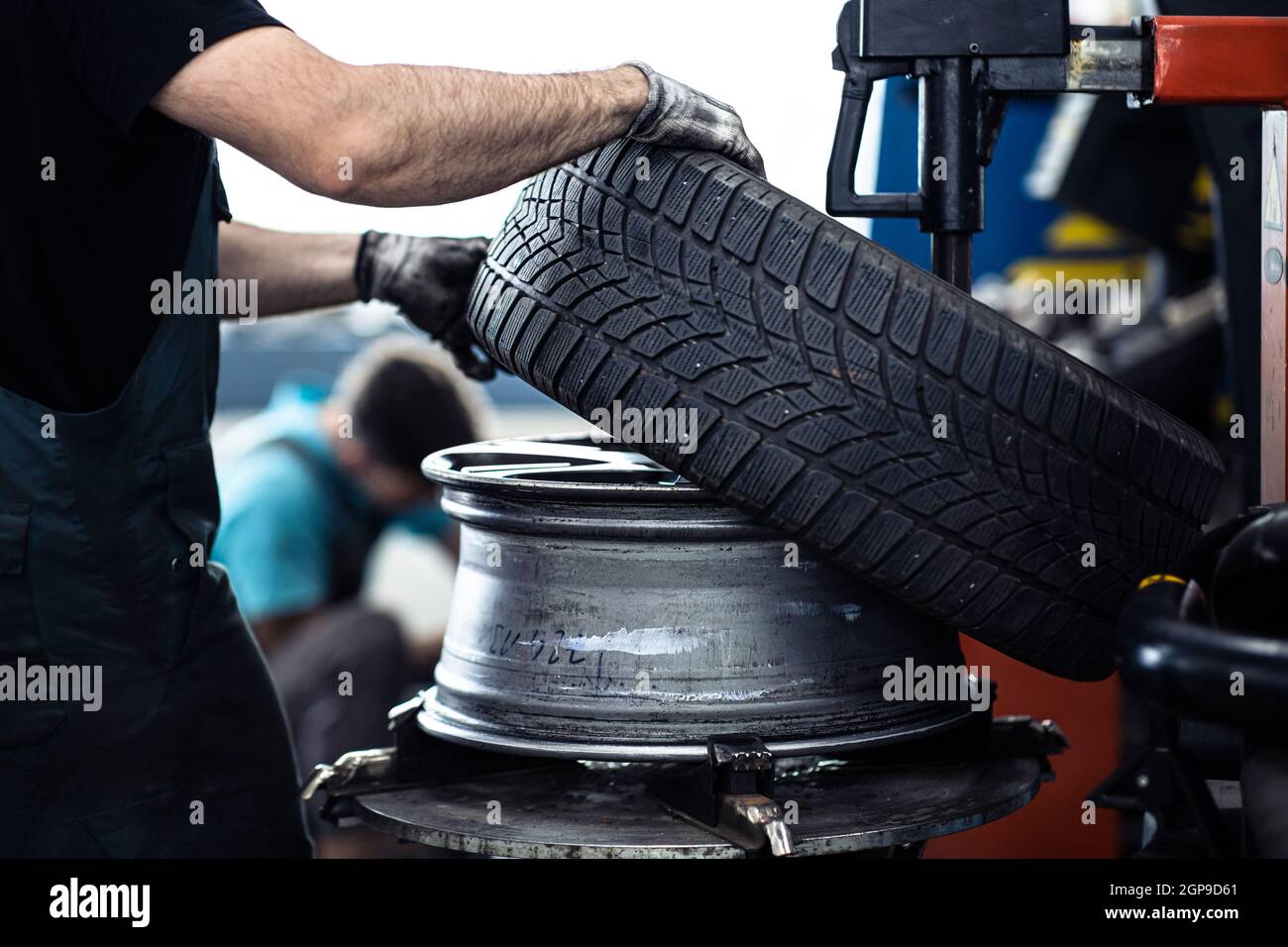 Car mechanic changing tires of a car in a repair shop,car garage ...