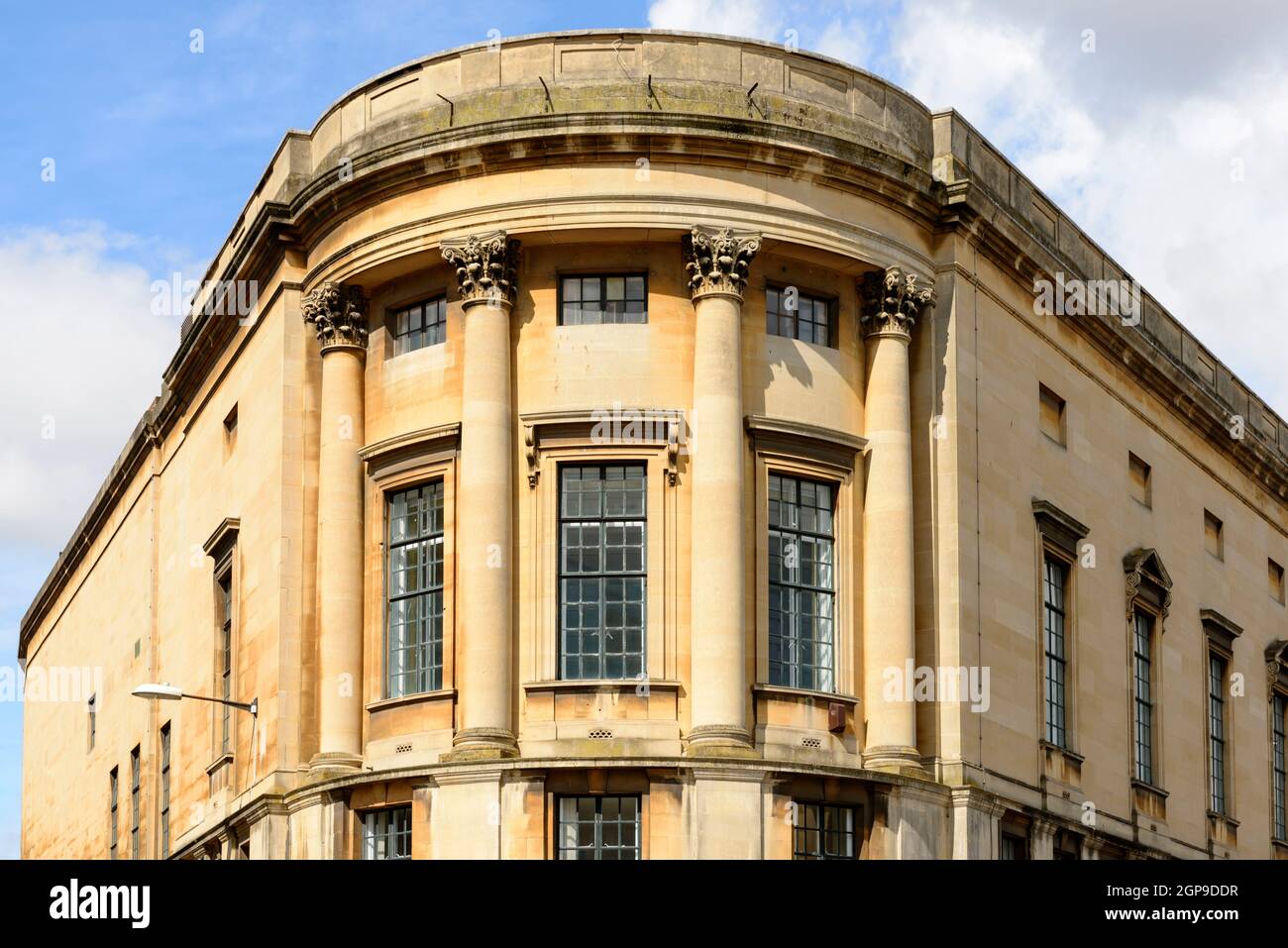 view of curved classical building in town center, with columns on round ...