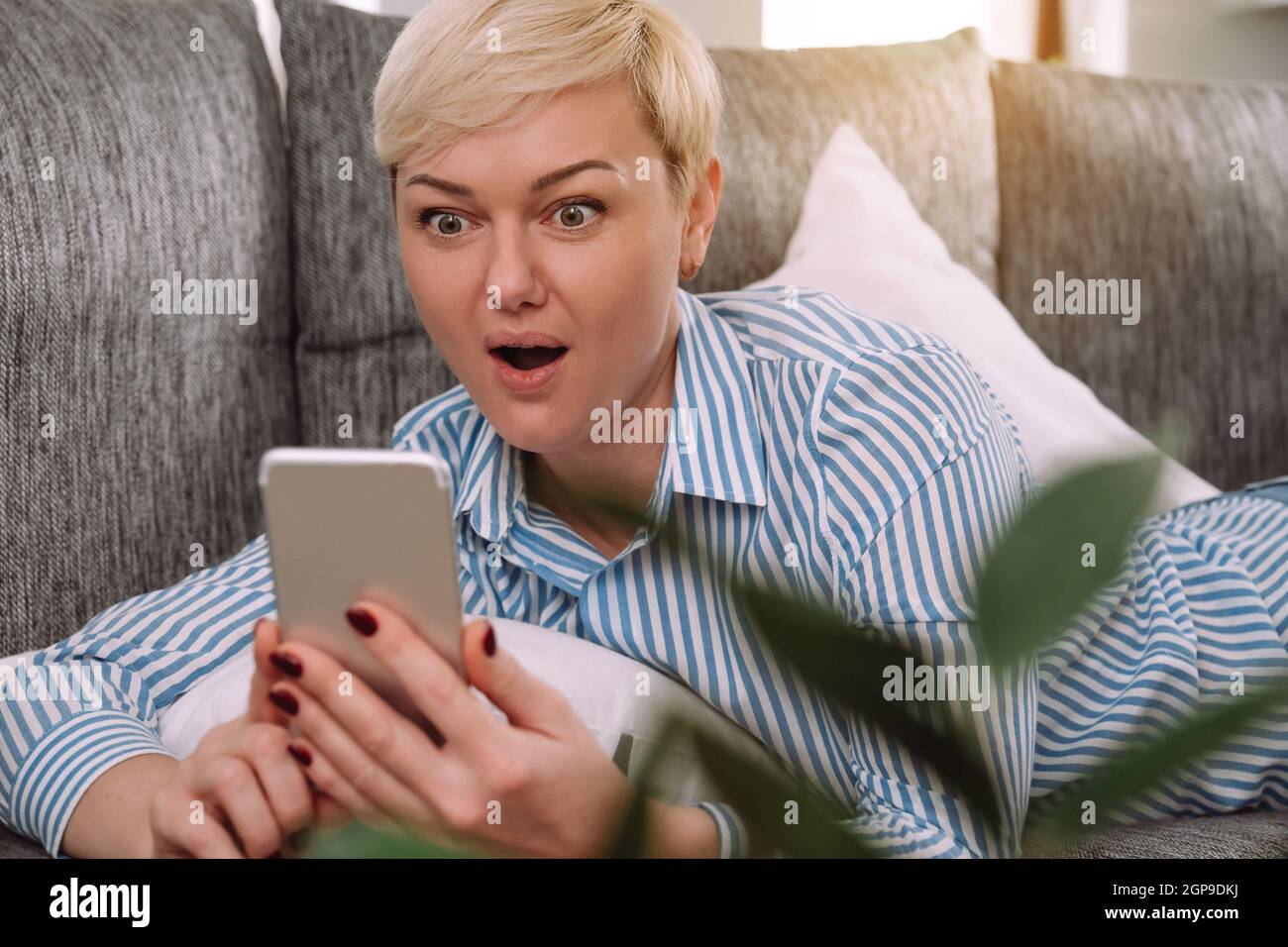 Woman holding phone happy reaction hi-res stock photography and images ...