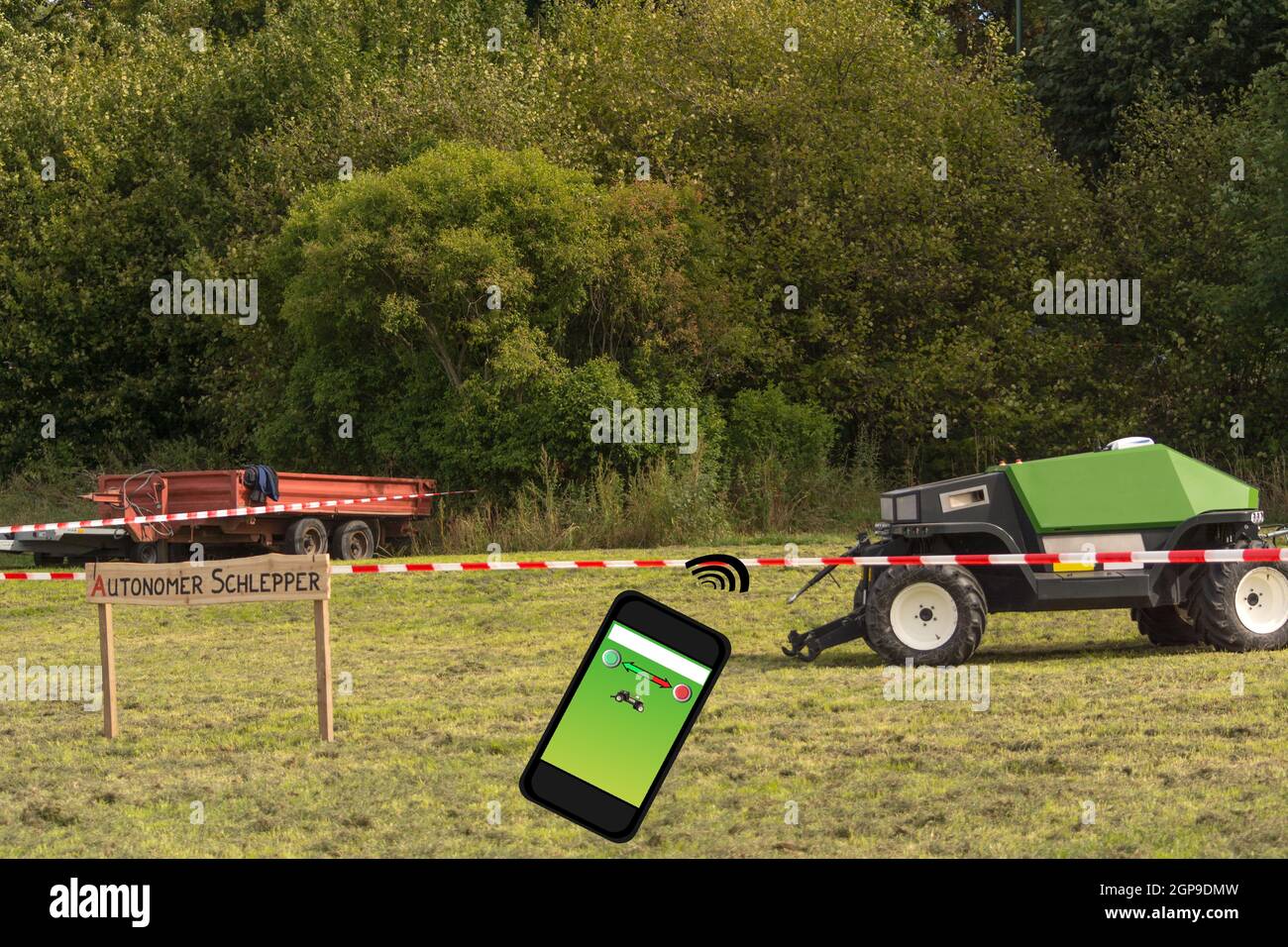 Autonomous tractor in the field. Wooden sign with inscription in German ...