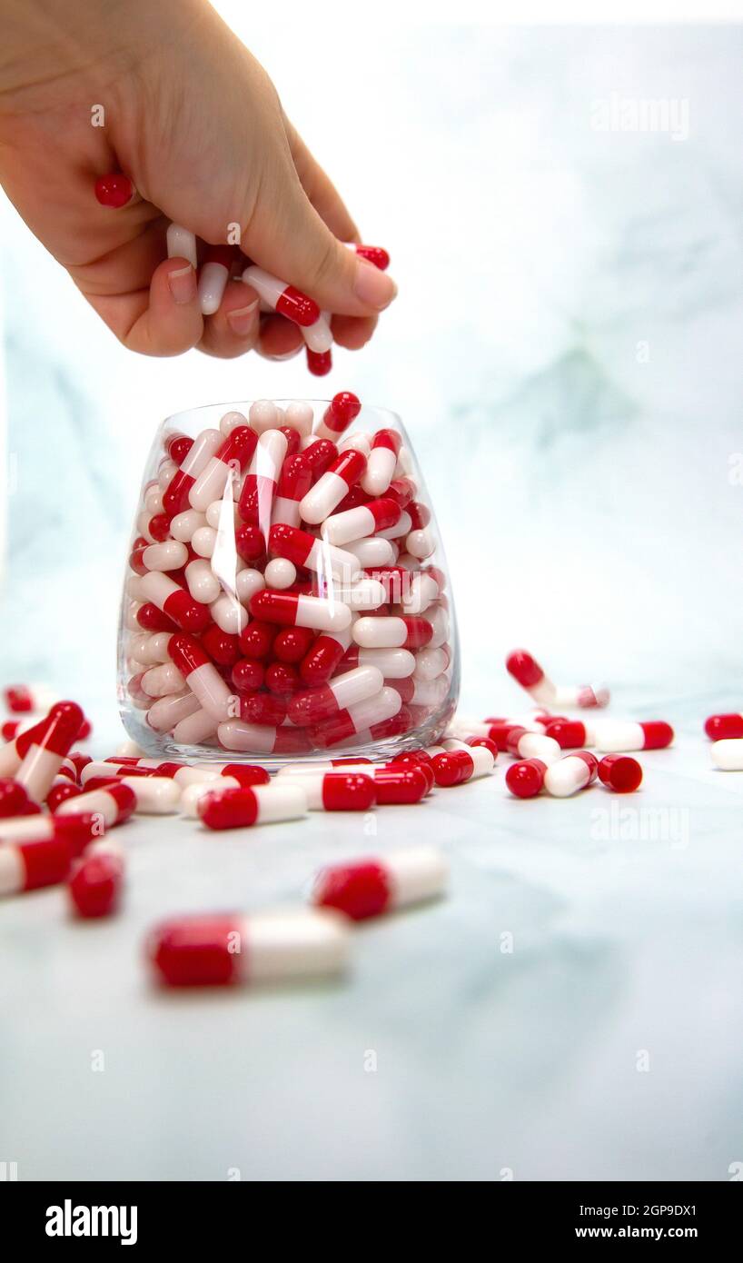 A hand grabbing hand full of medicines, Capsules for Vitamines,drugs ...