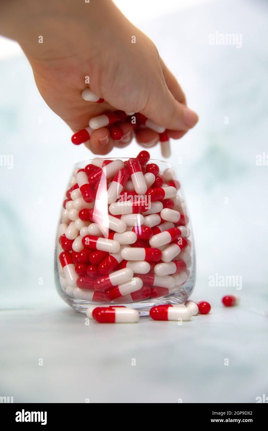 A hand grabbing hand full of medicines, Capsules for Vitamines,drugs ...
