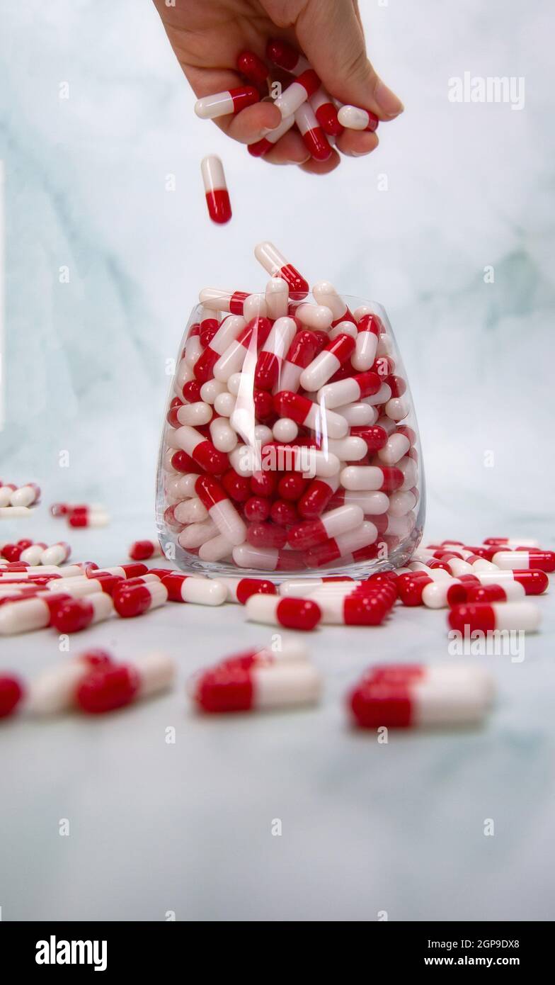A hand grabbing hand full of medicines, Capsules for Vitamines,drugs ...