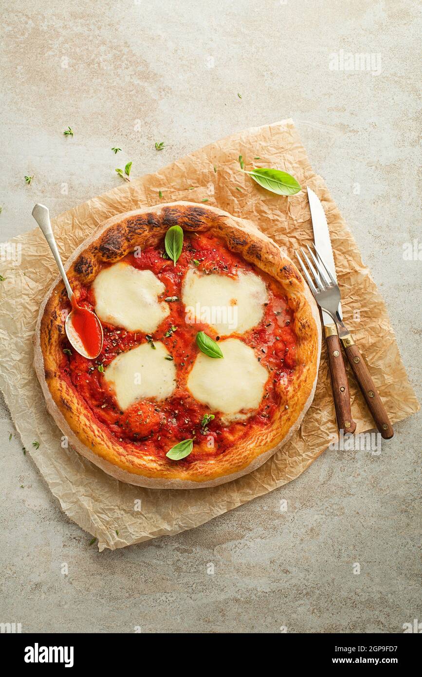 Pizza Margherita served with mozzarella cheese, tomato sauce and fresh basil Stock Photo - Alamy