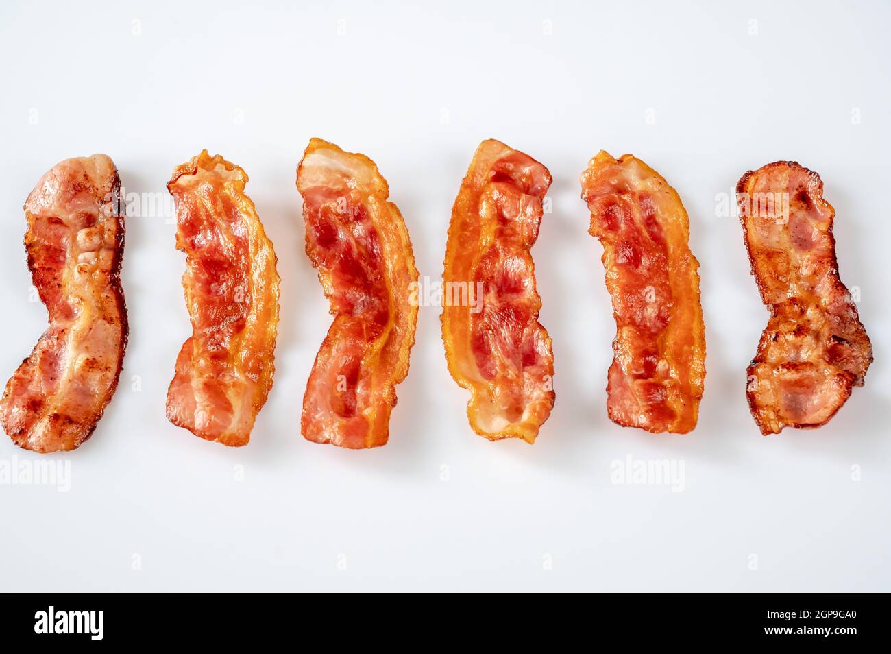 Fried bacon strips on the white background Stock Photo - Alamy