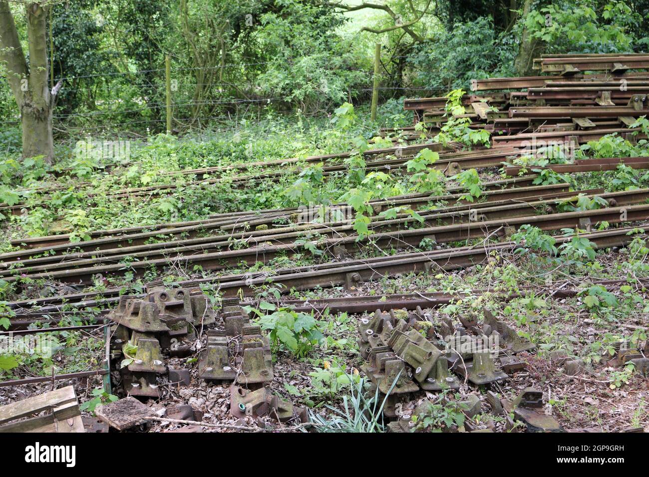 Heritage railway line track store with stacks of rusty railway lines ...