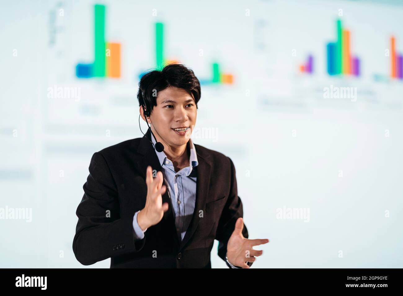 Male Asian Speaker Stands on Stage for Business Presentation Stock ...
