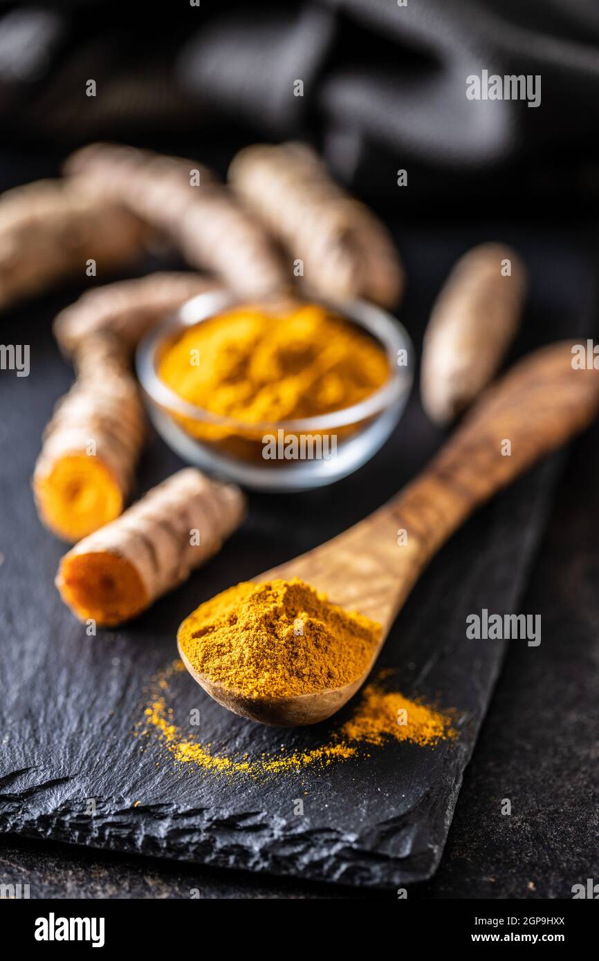 Indian turmeric powder and root. Turmeric spice. Ground turmeric in ...