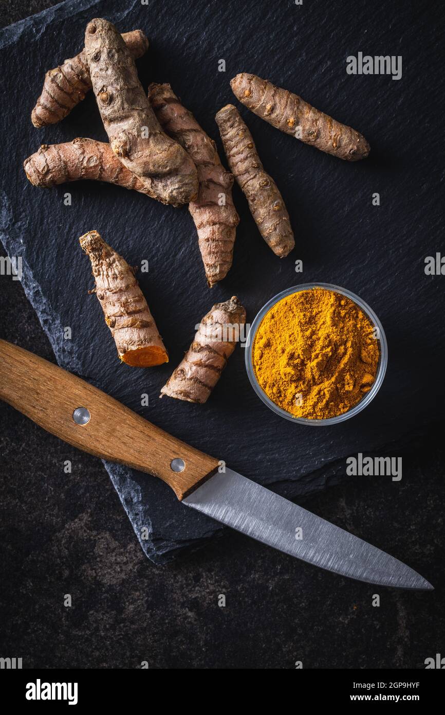 Indian turmeric powder and root. Turmeric spice. Ground turmeric in ...