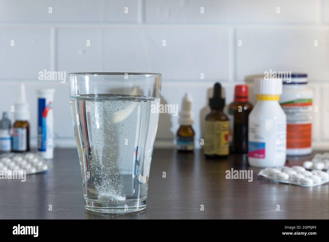 Tablets are dissolved in a glass of water against the background of ...