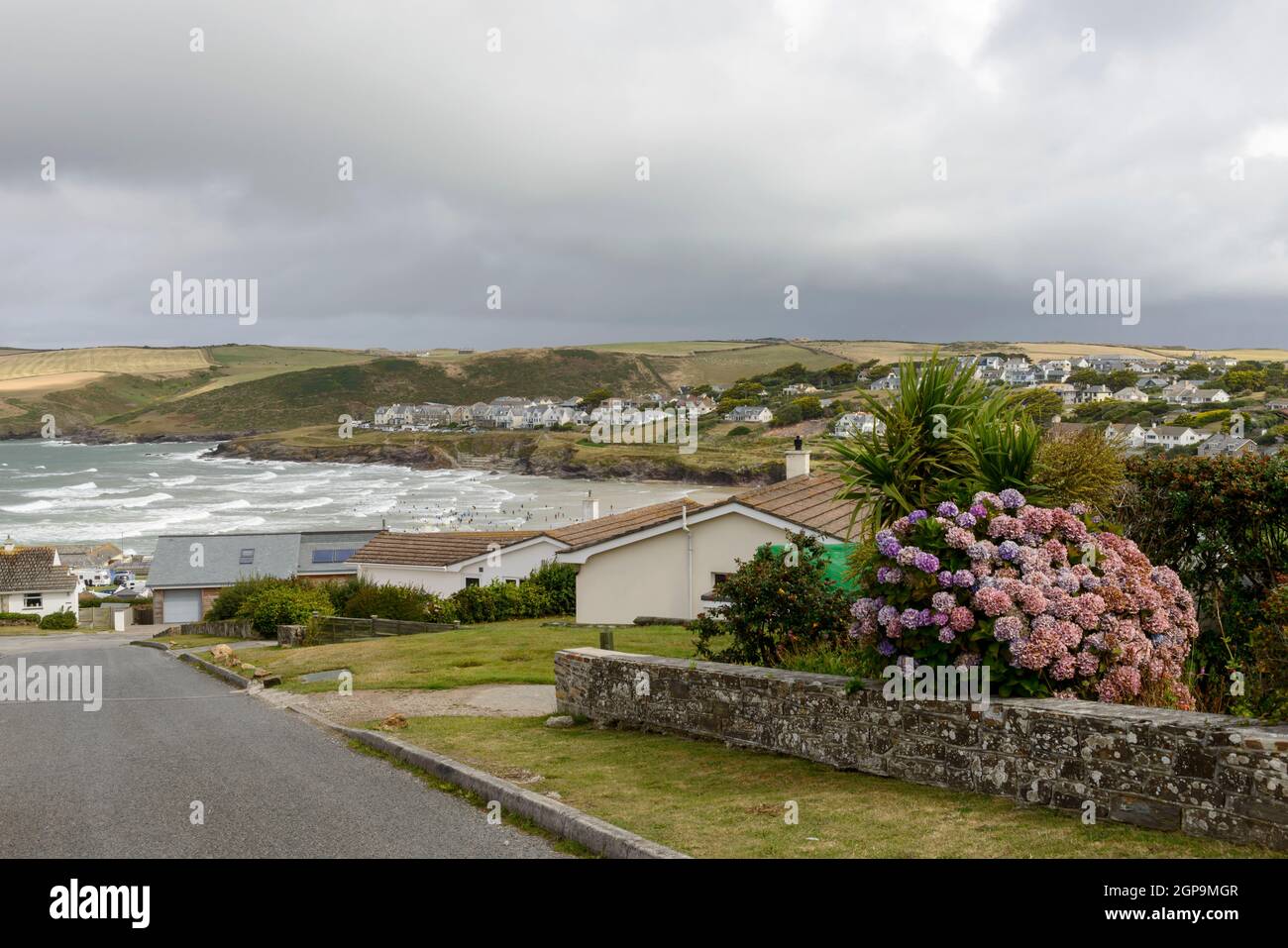 view of the bay and the beach of touristic village in Cornwall with a ...