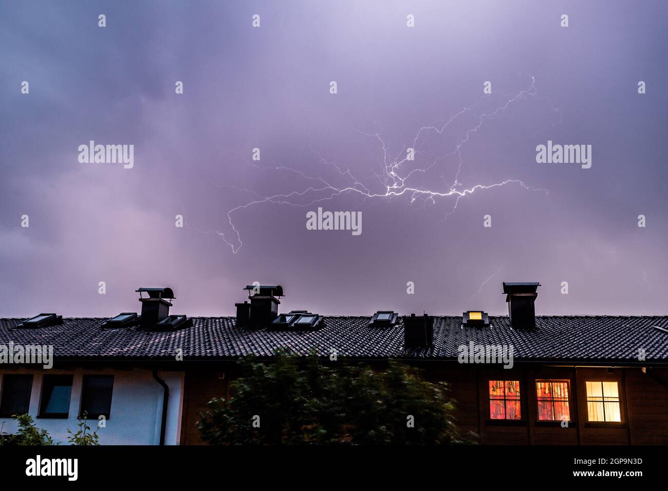 Lightning on the colored sky, roof of a building Stock Photo - Alamy