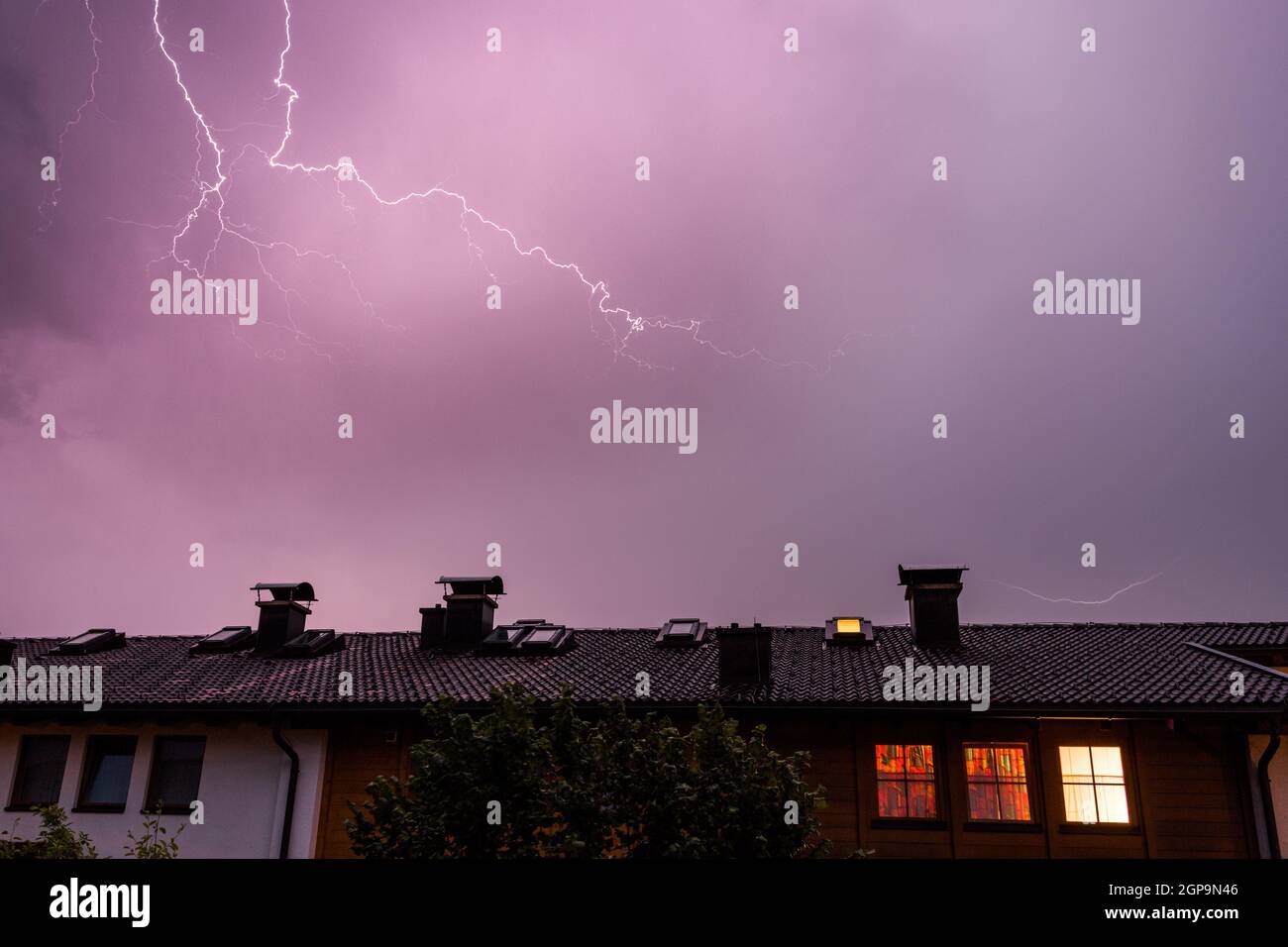Lightning on the colored sky, roof of a building Stock Photo - Alamy