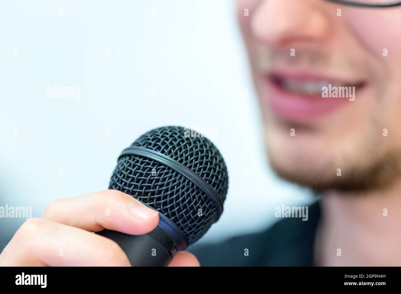 Man holding microphone interviewing hi-res stock photography and images ...