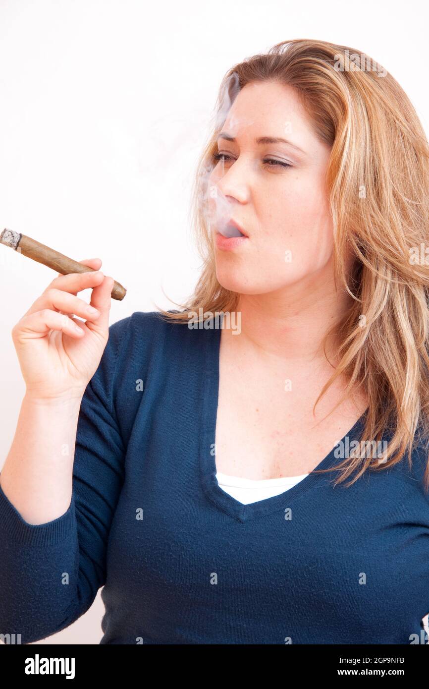 Beautiful woman smoking cigar hi-res stock photography and images - Alamy