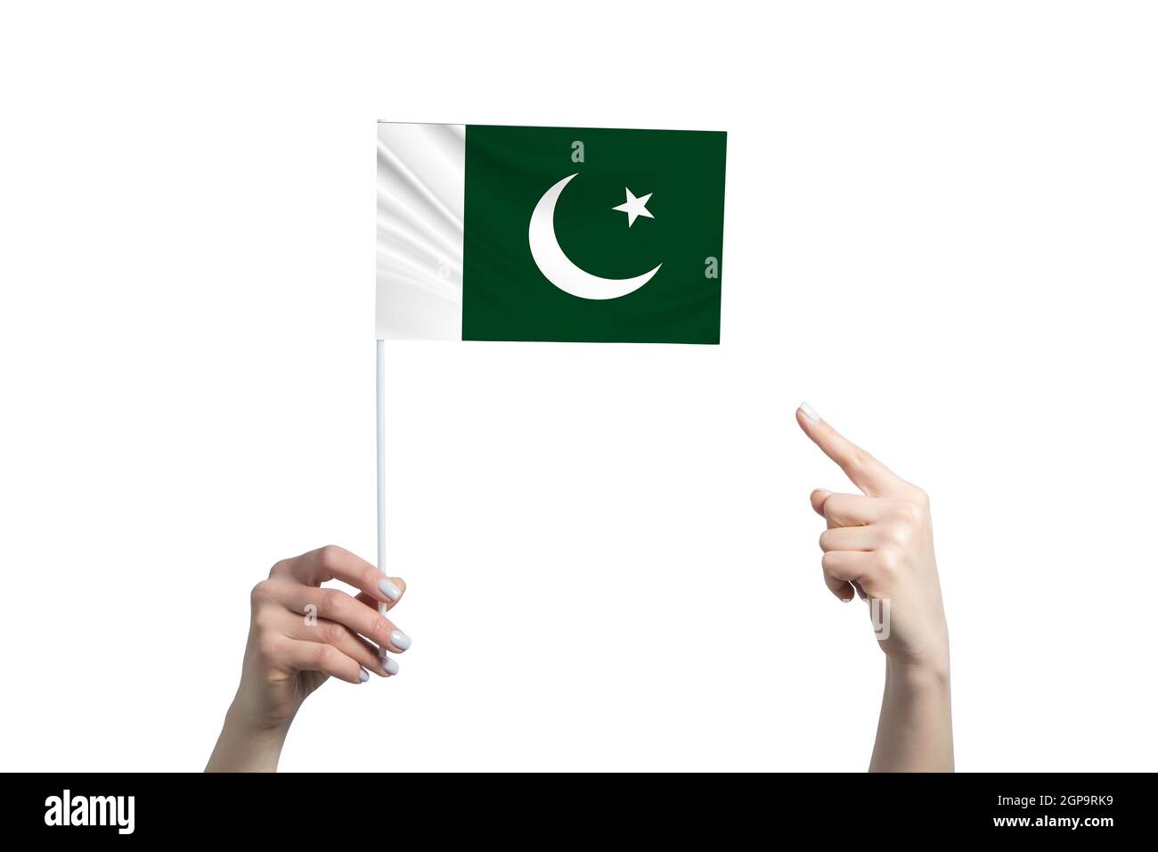 A beautiful female hand holds a Pakistan flag to which she shows the ...