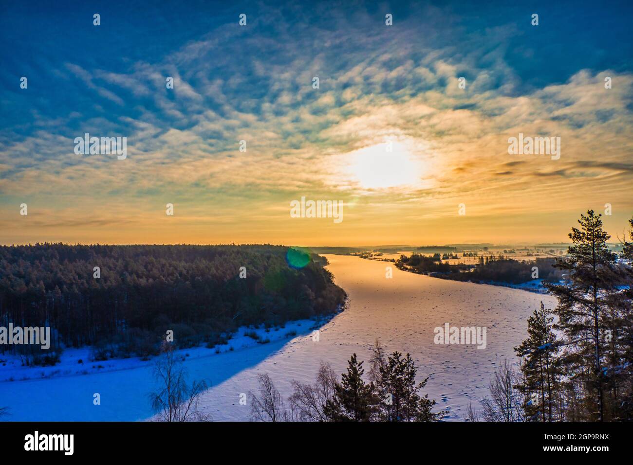 Breathtaking Sunrise with Golden Clouds over Frozen River Stock Photo ...